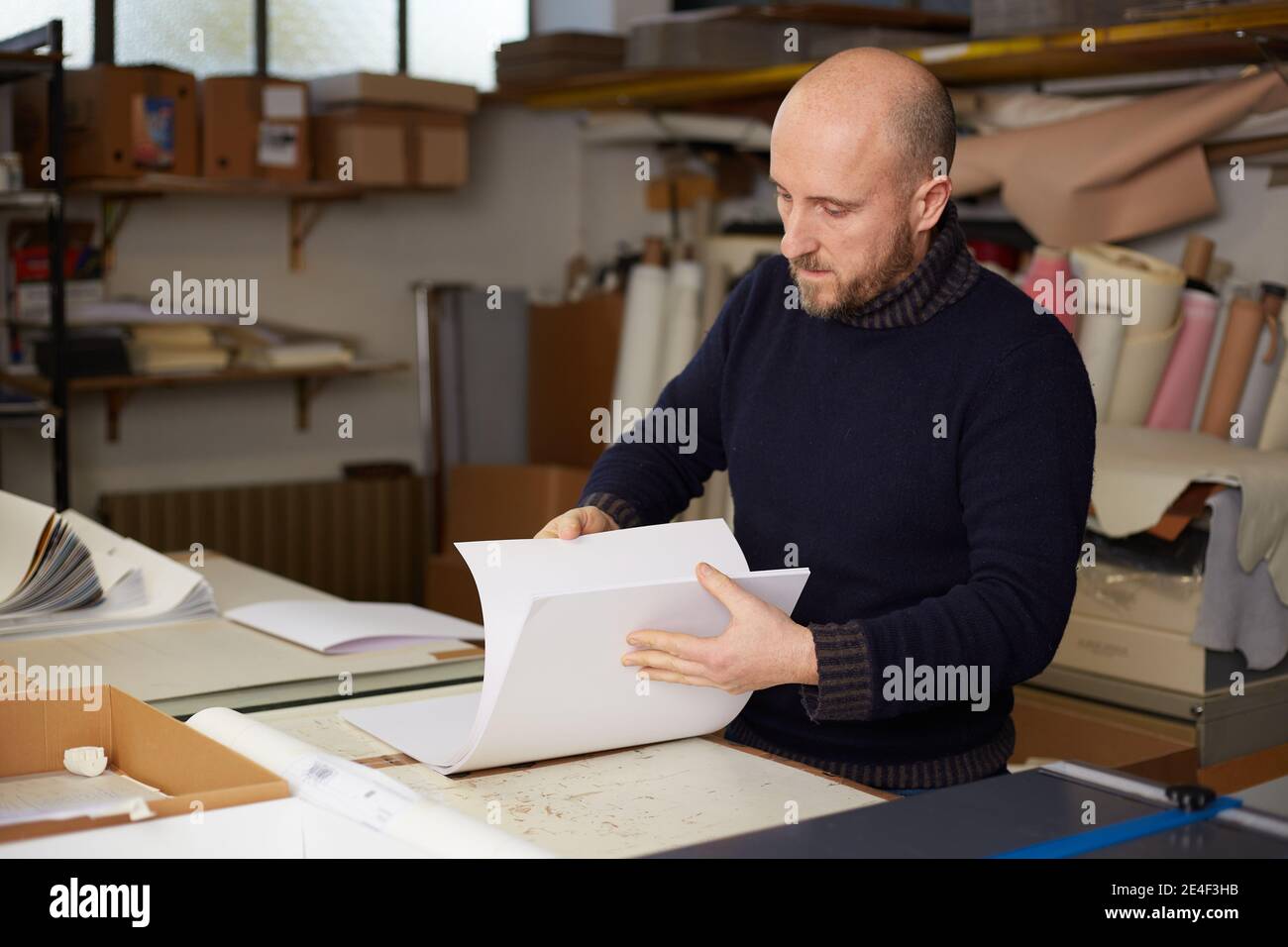book binder working in a warehouse Stock Photo - Alamy