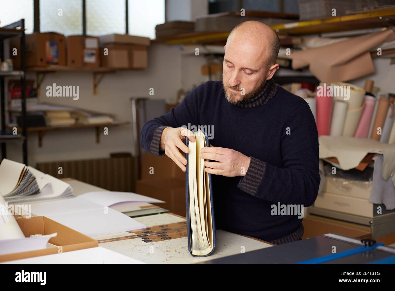 book binder working in a warehouse Stock Photo - Alamy