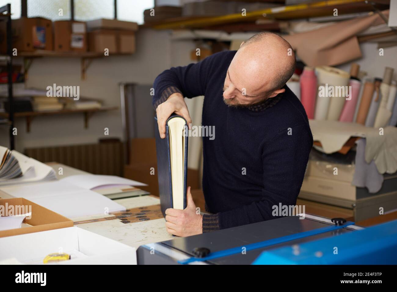 book binder working in a warehouse Stock Photo - Alamy