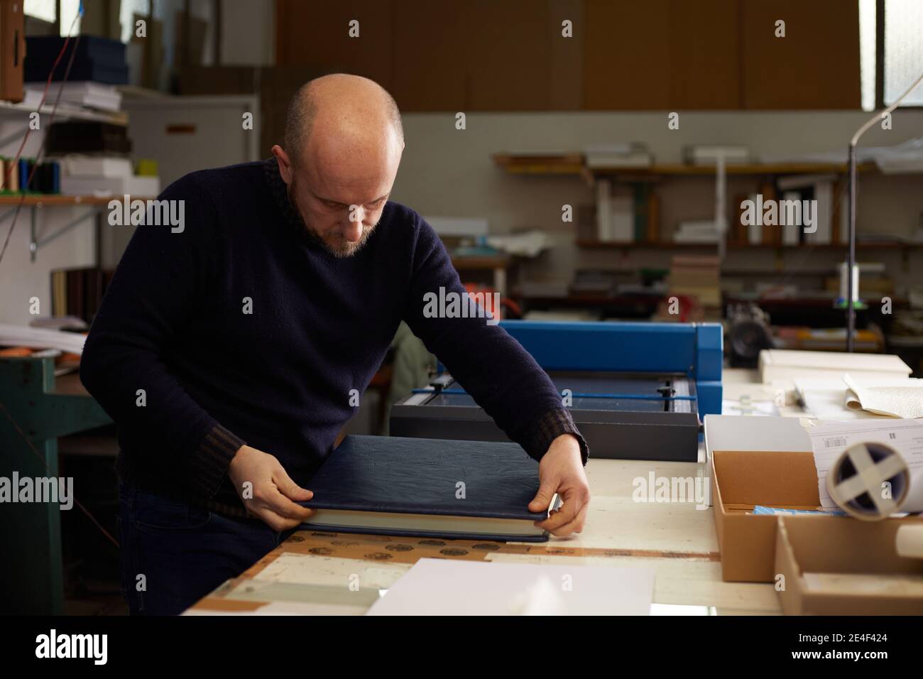 book binder working in a warehouse Stock Photo - Alamy