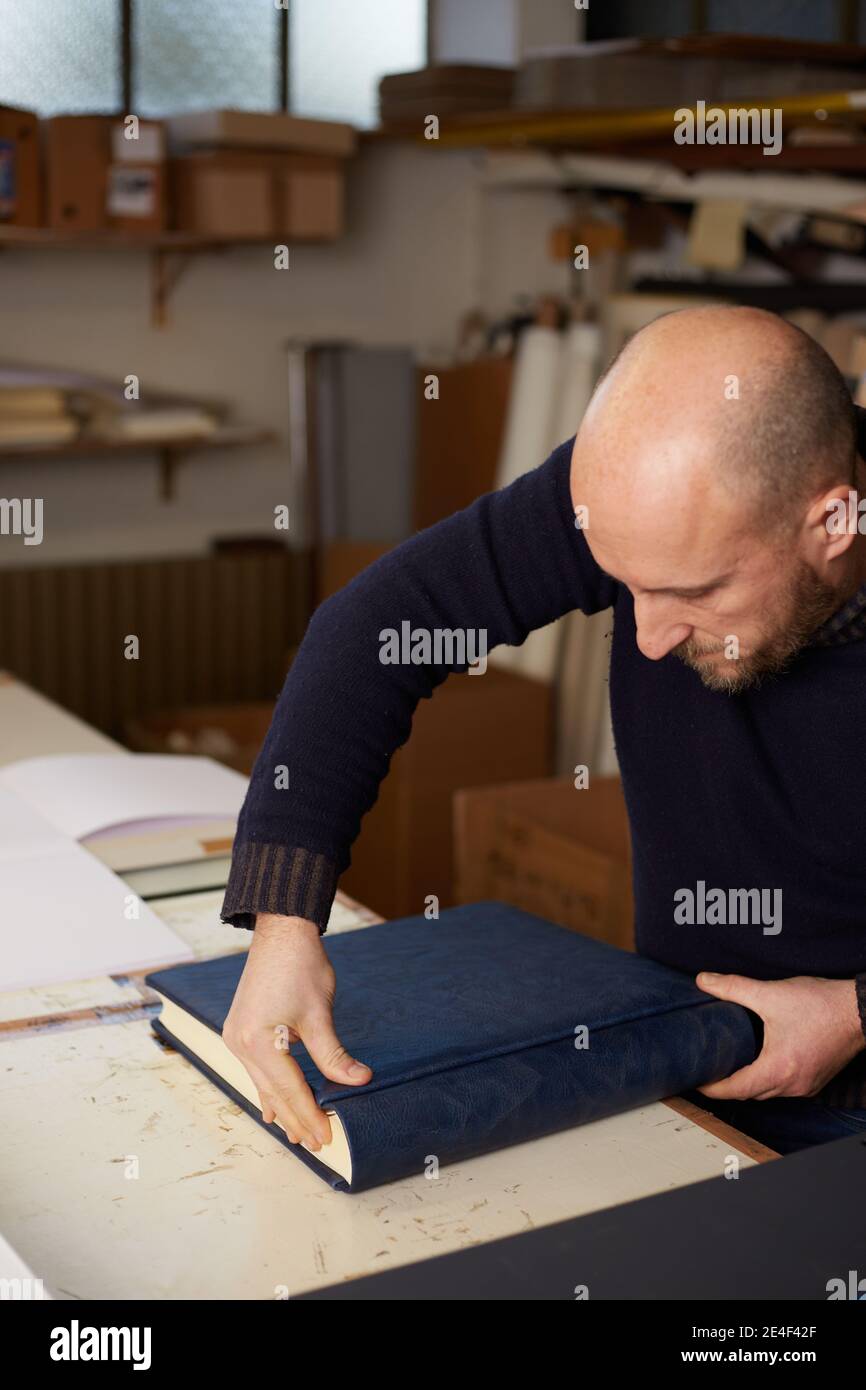 book binder working in a warehouse Stock Photo - Alamy