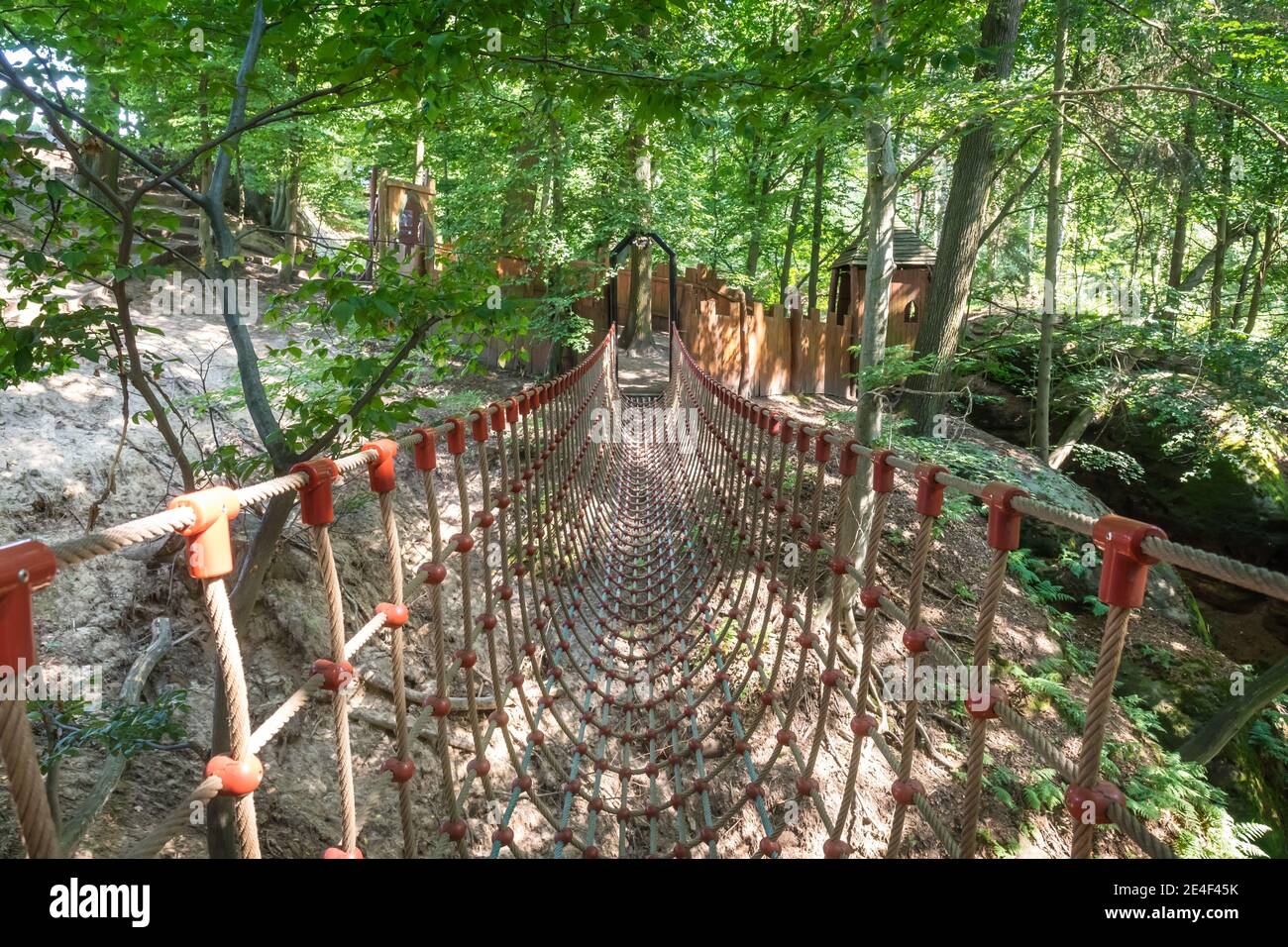 Suspension rope bridge over a rocky valley in forest Stock Photo - Alamy