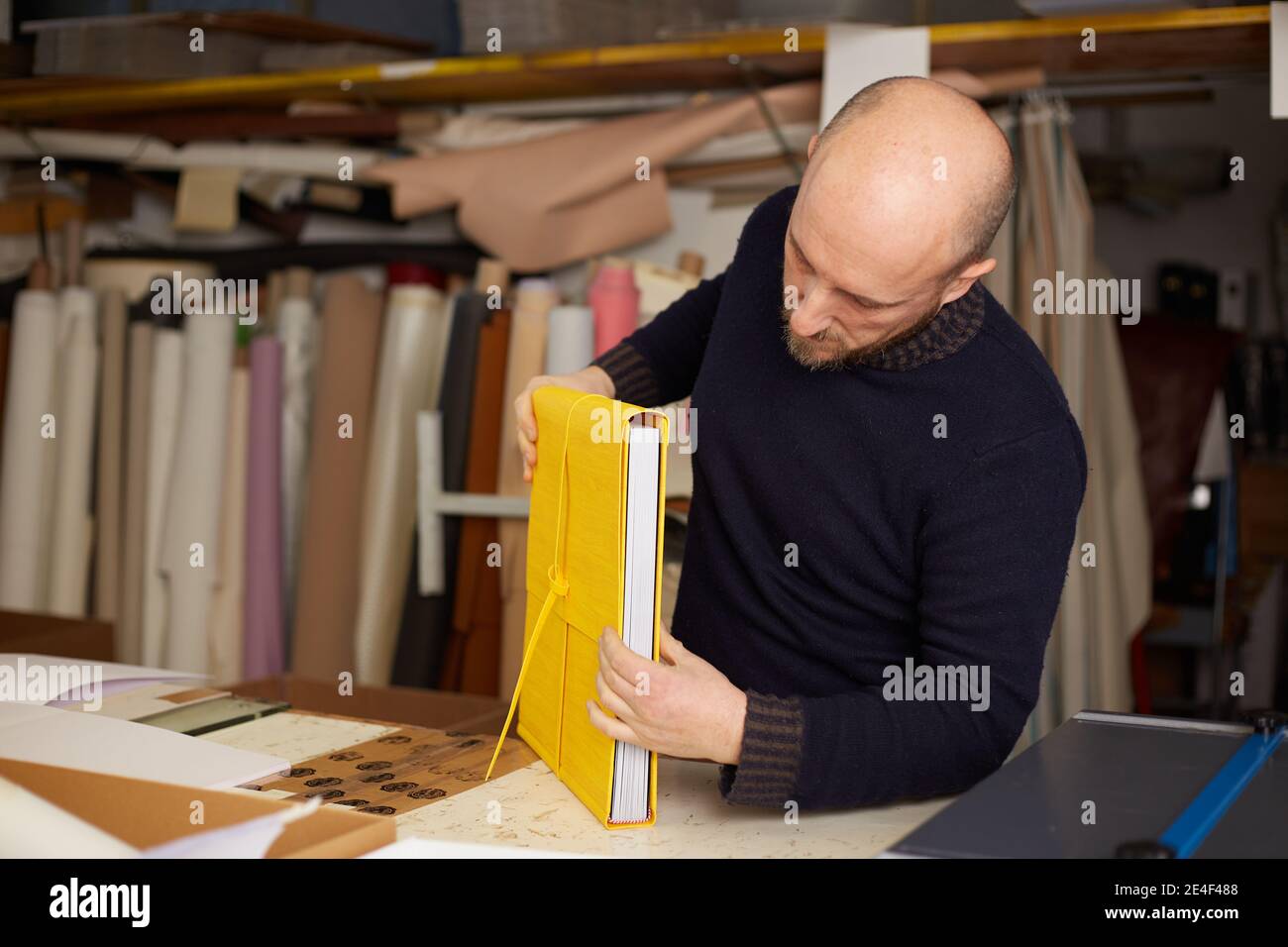 book binder working in a warehouse Stock Photo - Alamy