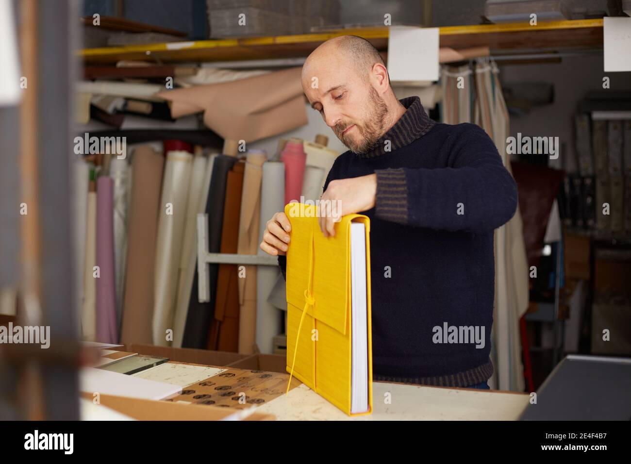 book binder working in a warehouse Stock Photo - Alamy