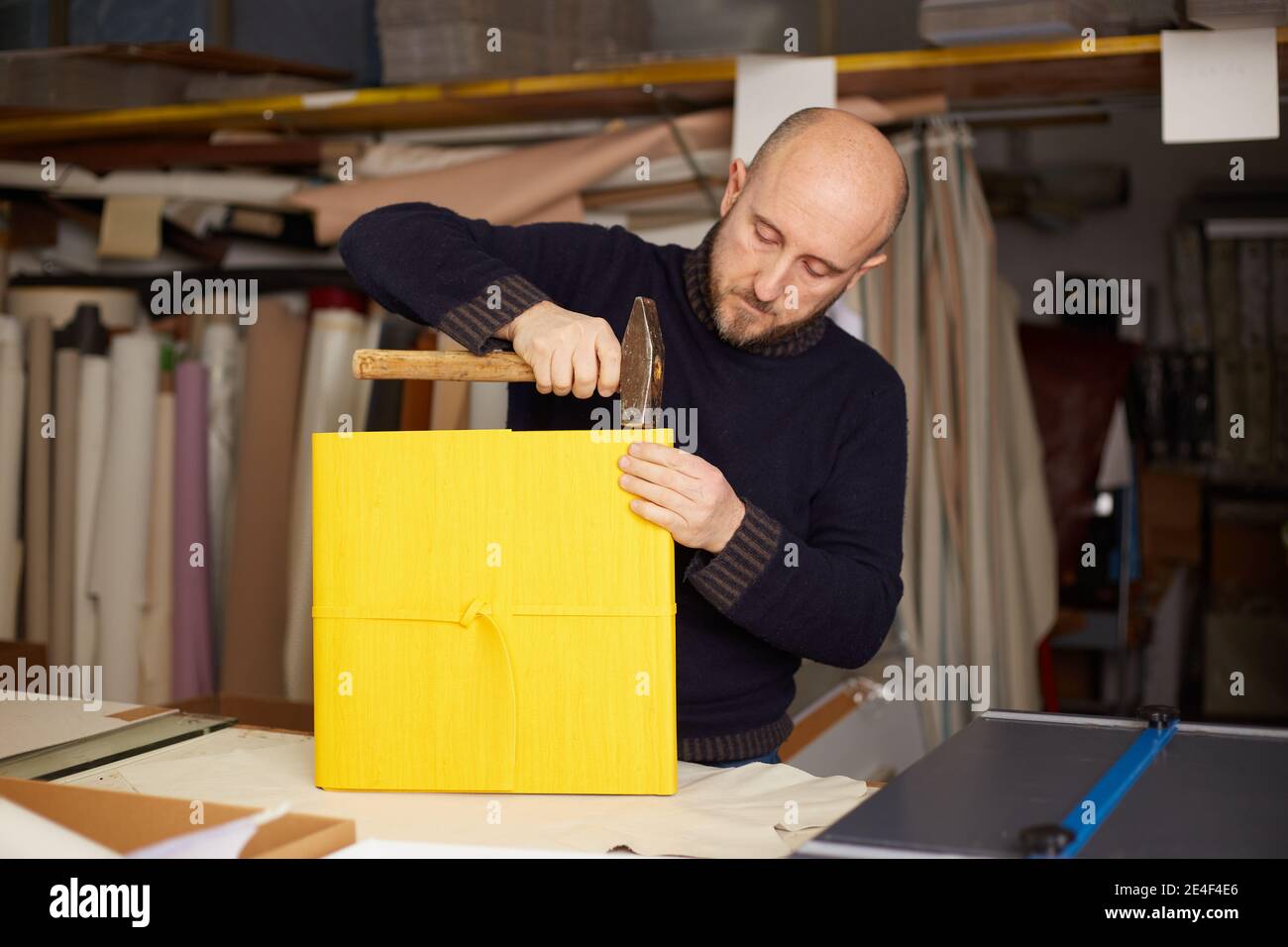 book binder working in a warehouse Stock Photo - Alamy