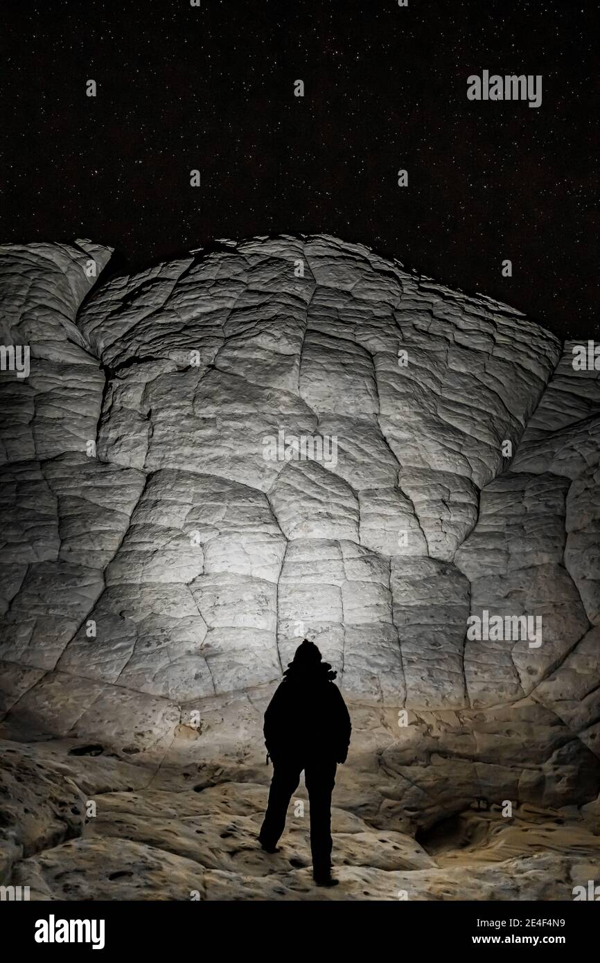 Karen Rentz illuminating a cauliflower rock formation in White Pocket ...