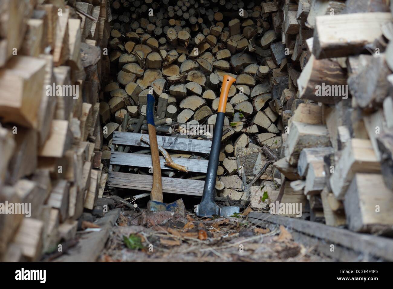 Inside garden shed with stacked wood and axes Stock Photo - Alamy