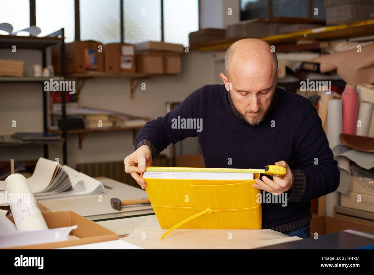 book binder working in a warehouse Stock Photo - Alamy