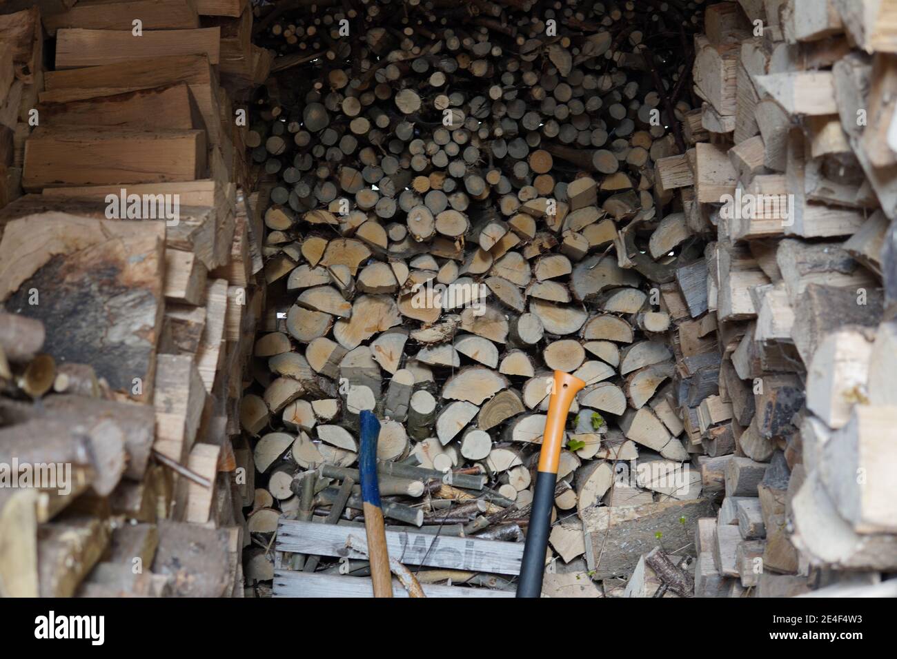 Inside garden shed with stacked wood and axes Stock Photo - Alamy
