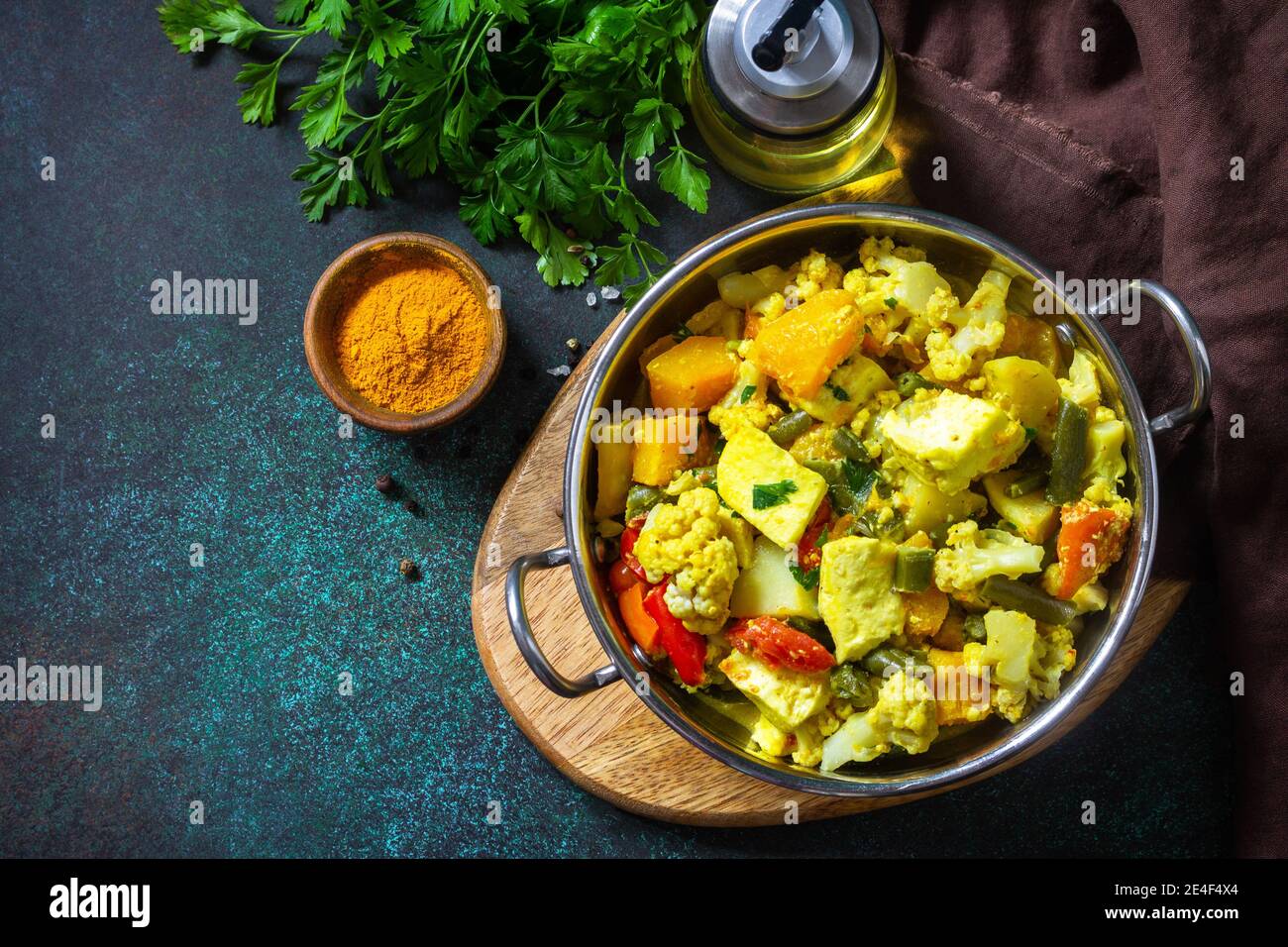 Sabji, Stewed pumpkin with soft cheese and vegetables on a dark stone ...