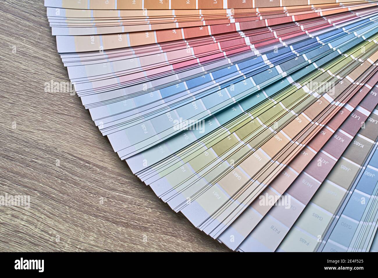 Color wheel palette for choosing paint tone. Various colors on wooden ...