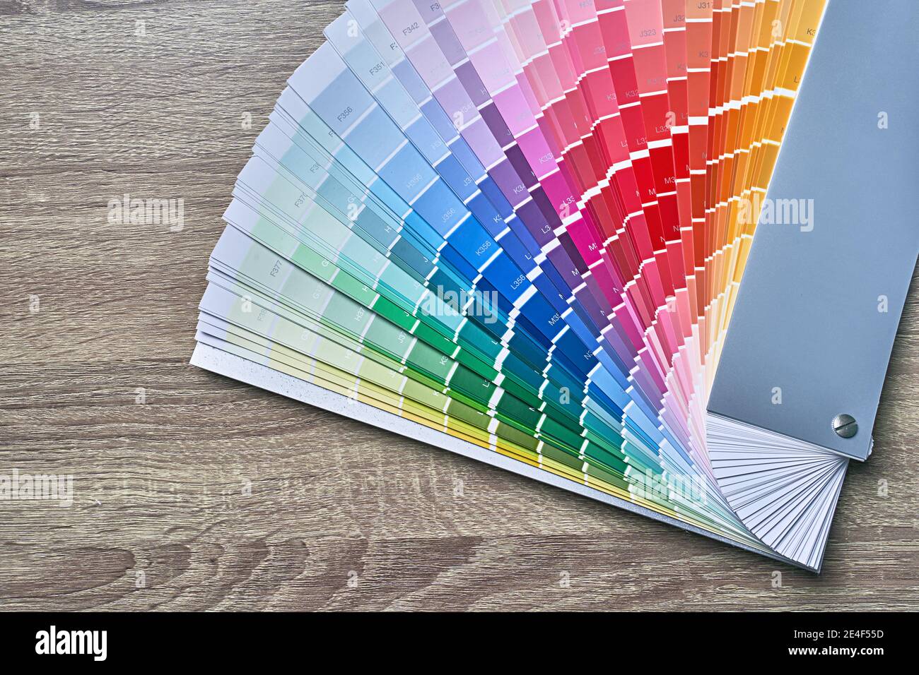 Color wheel palette for choosing paint tone. Various colors on wooden ...