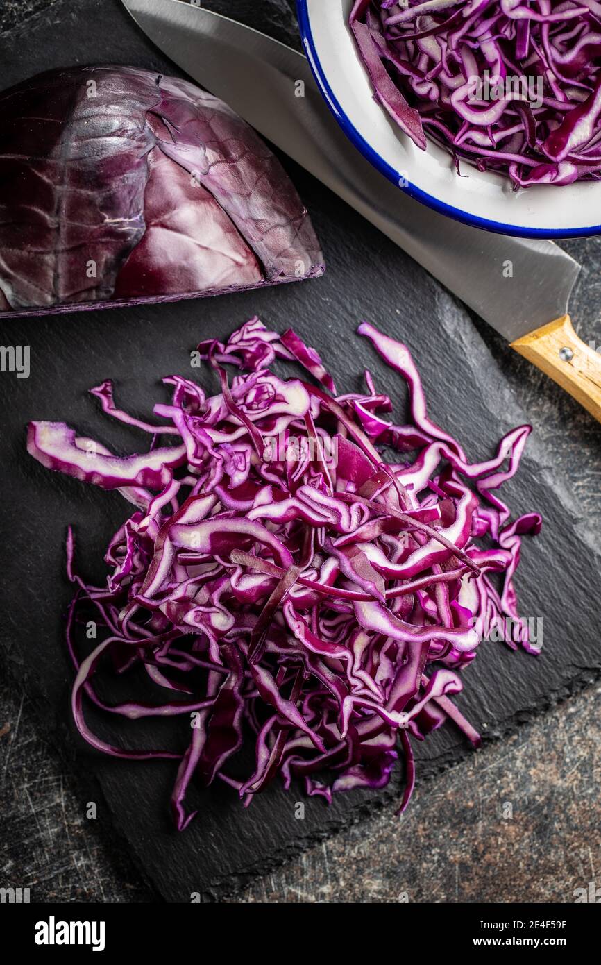 Sliced fresh red cabbage on black table. Top view Stock Photo - Alamy