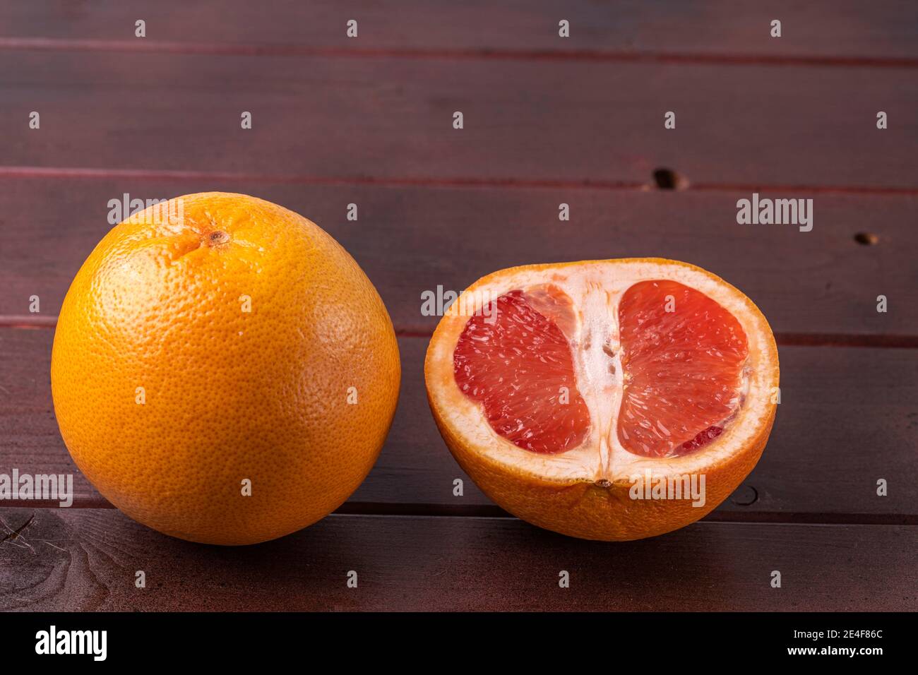 Close up view of grapefruit isolated on wood background. Healthy eating ...