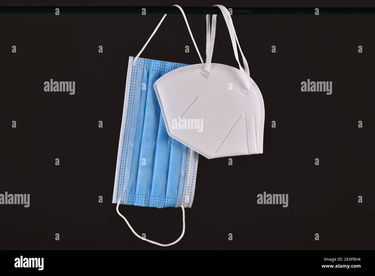 Medical FFP2 respirator and surgical face mask on dark background Stock ...