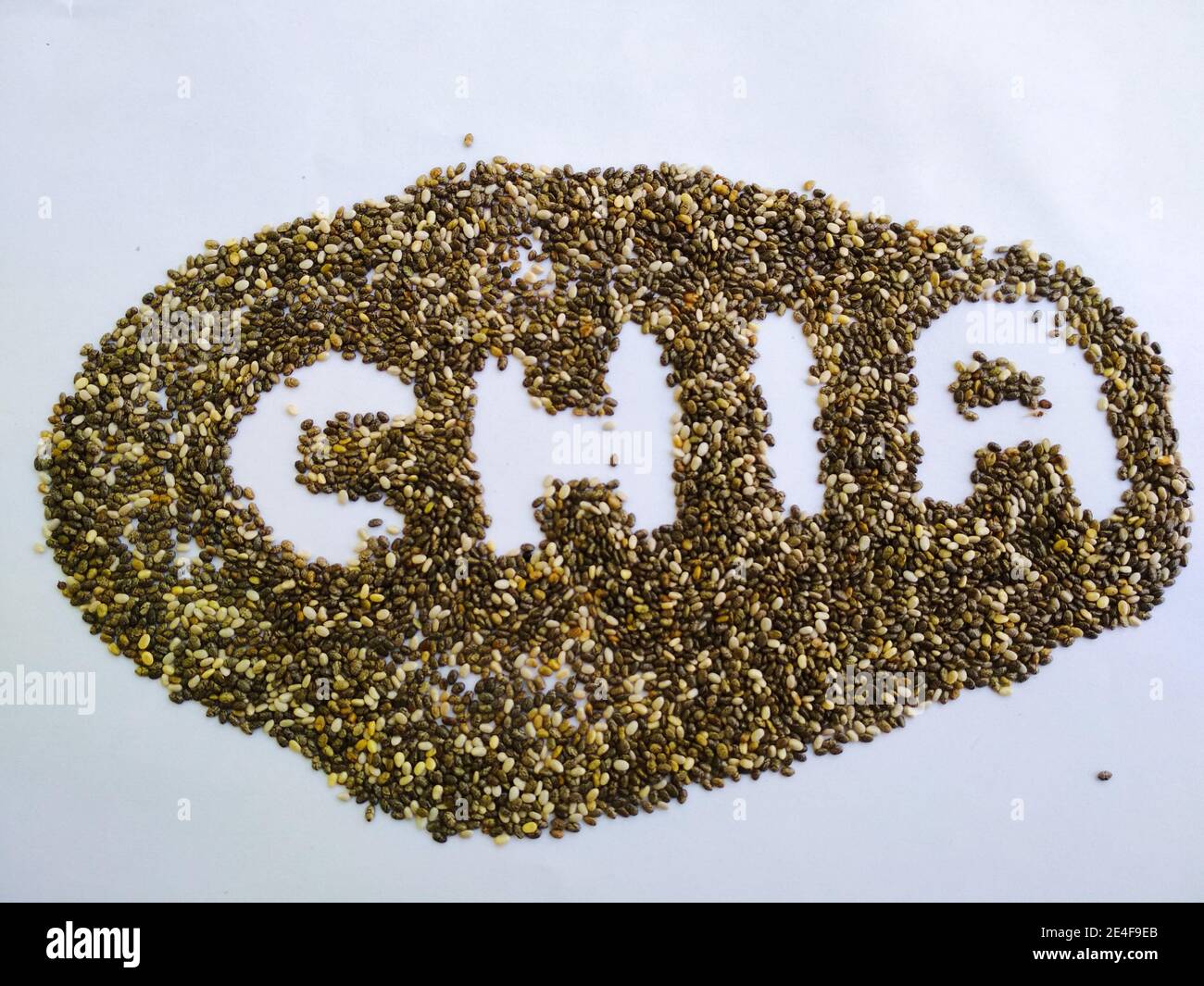 Pile of chia seeds on a white background with chia word made on it ...
