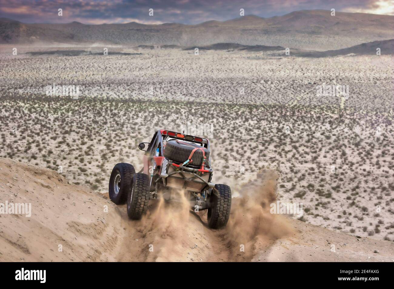 An ULTRA4 off road racing car careers though the desert during the ...