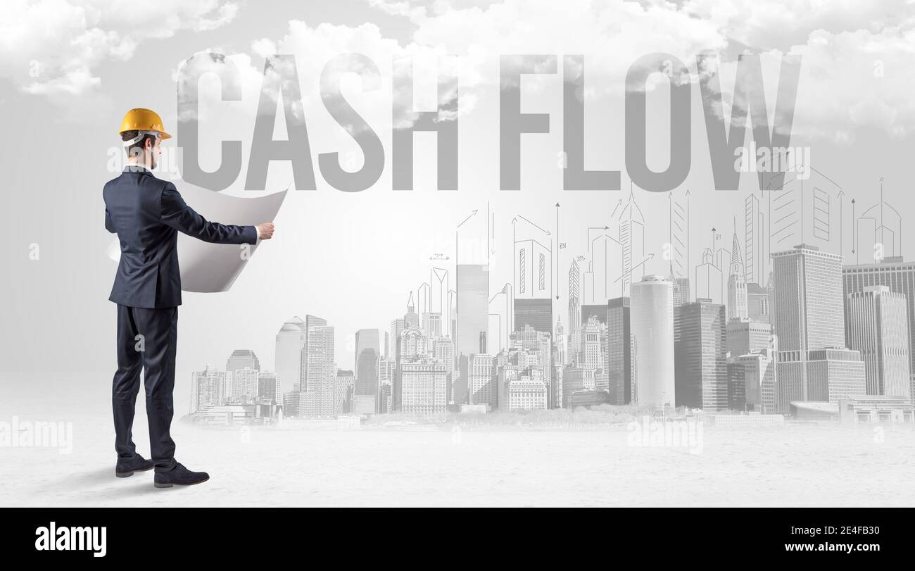 Young businessman with hard hat and CASH FLOW inscription, new business ...