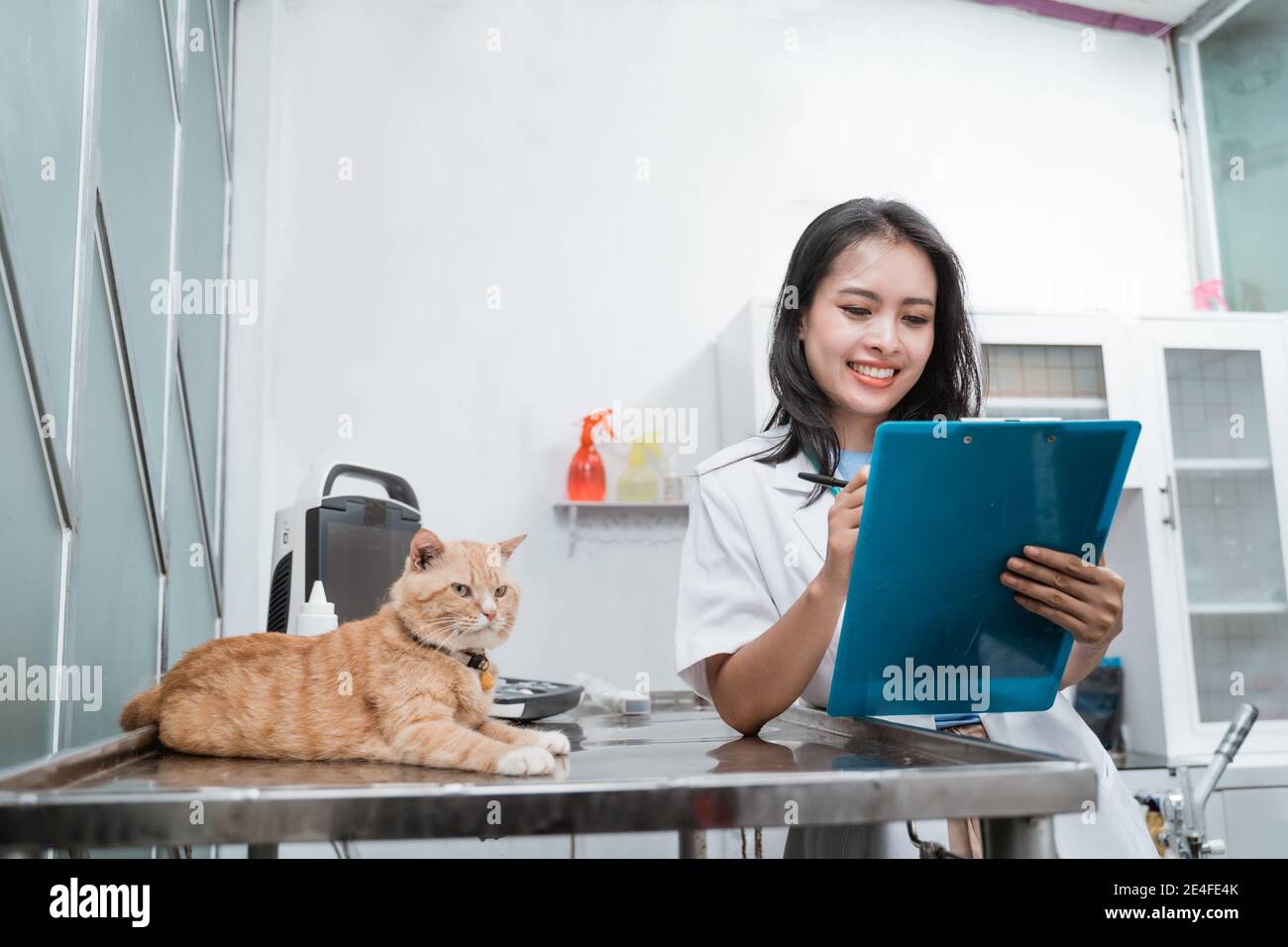 Doctor sits writing hi-res stock photography and images - Alamy