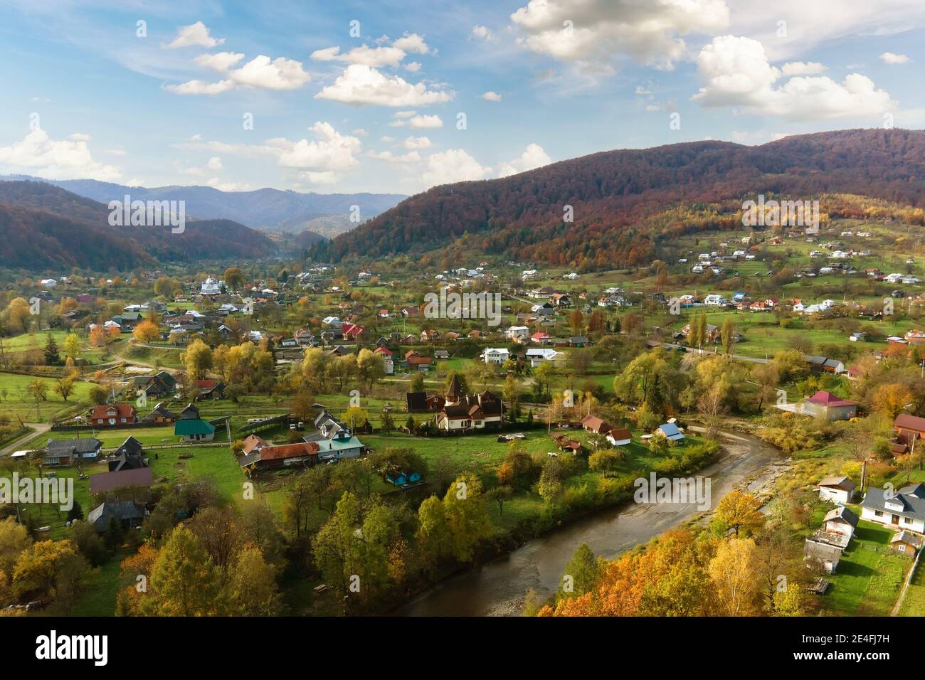 Aerial view of a rural village with small houses between autumn ...