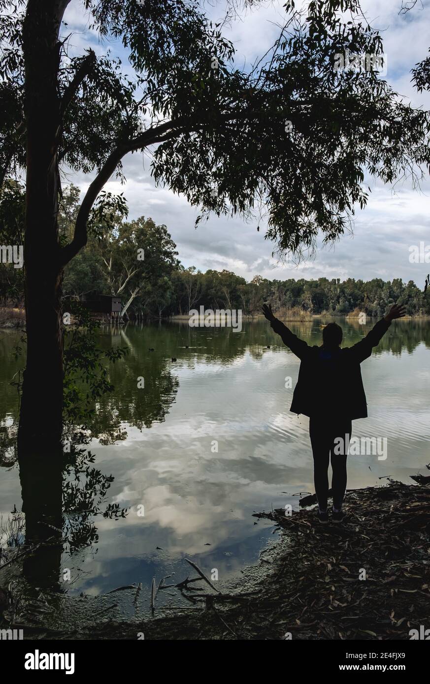 Unrecognised person standing and enjoying the scenery at a lake Stock ...