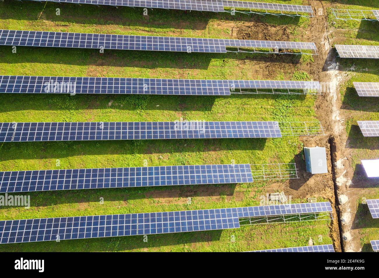 Aerial view of solar power plant under construction on green field ...