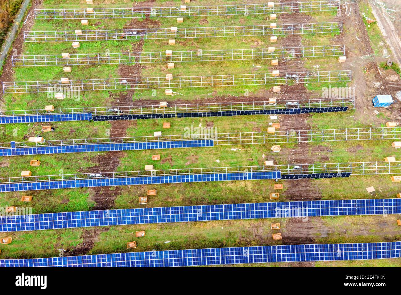 Aerial view of solar power plant under construction on green field ...