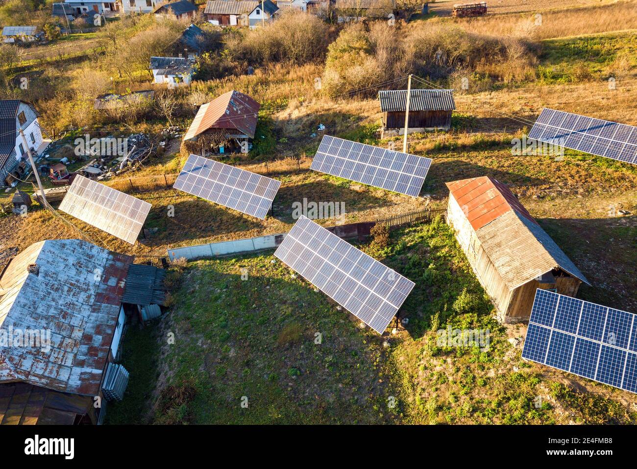 Aerial top down view of solar photo voltaic panels in green rural area ...
