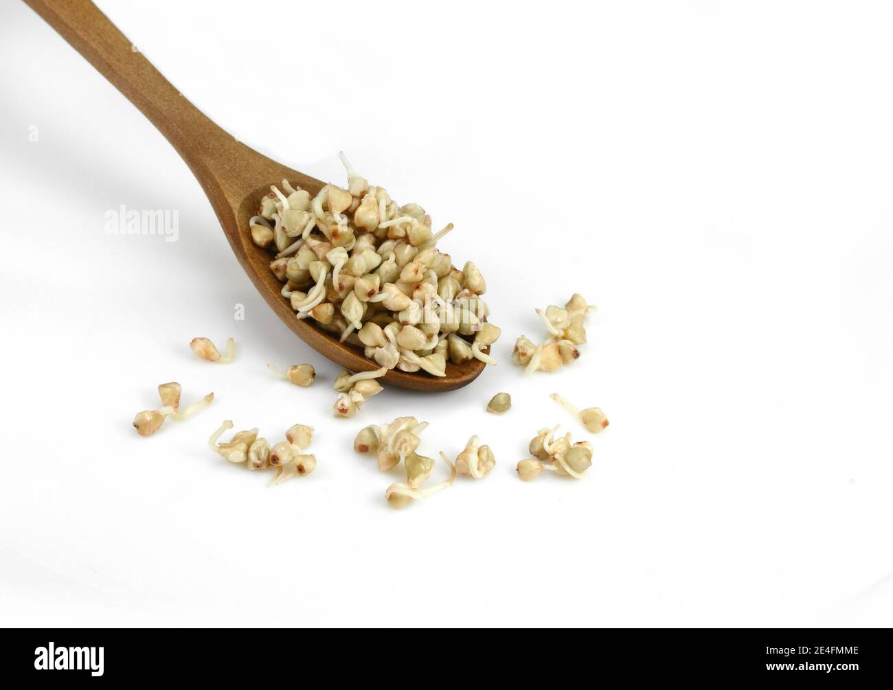 Buckwheat sprouts in a wooden spoon isolated on white background ...