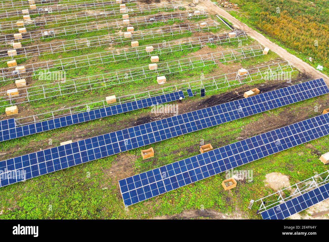 Aerial view of solar power plant under construction on green field ...
