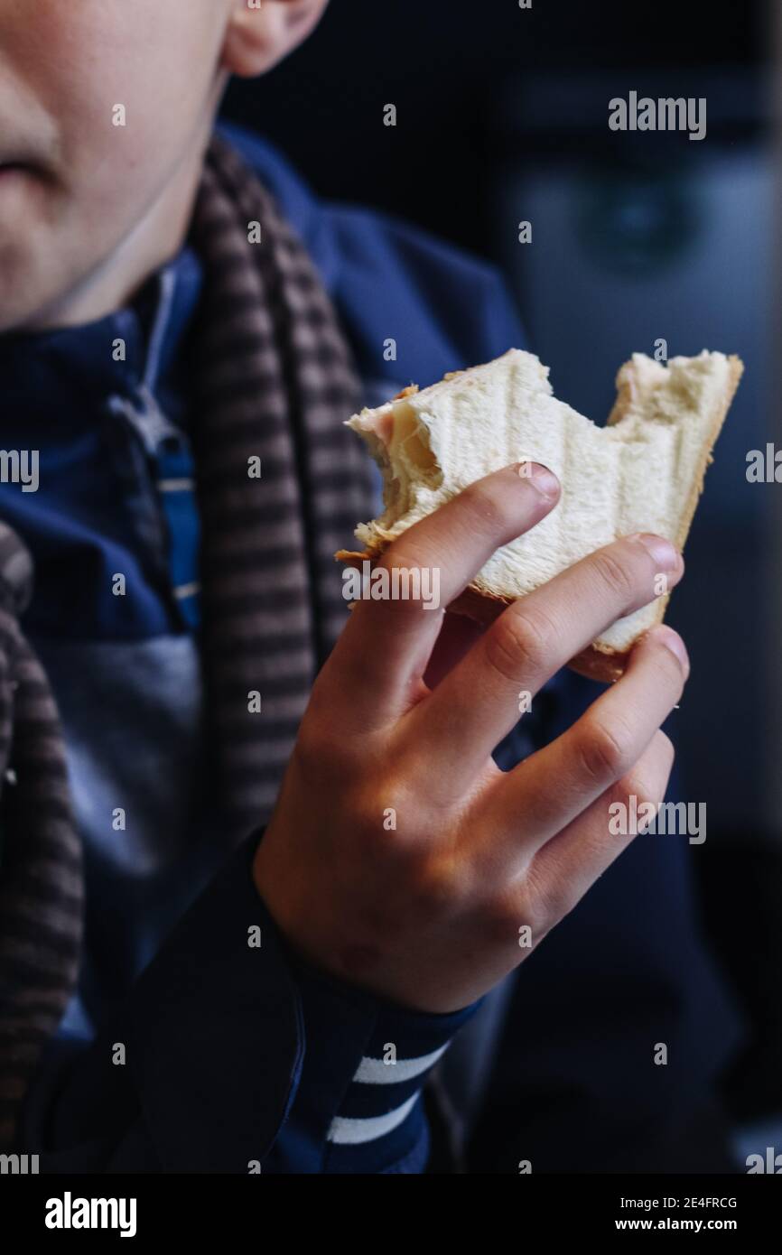 Bitten Sandwich with Ham in the Boy's Hand Stock Photo - Alamy