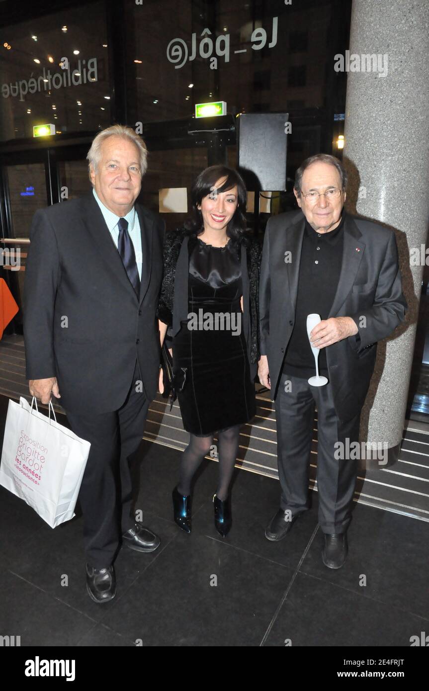 Massimo Gargia poses with a friend and Robert Hossein during a visit to ...