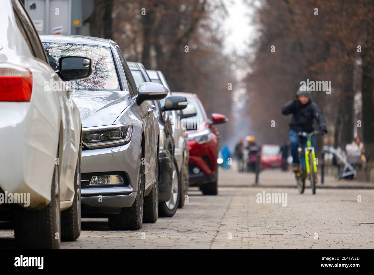 Cars parked in a row on a city street side Stock Photo - Alamy