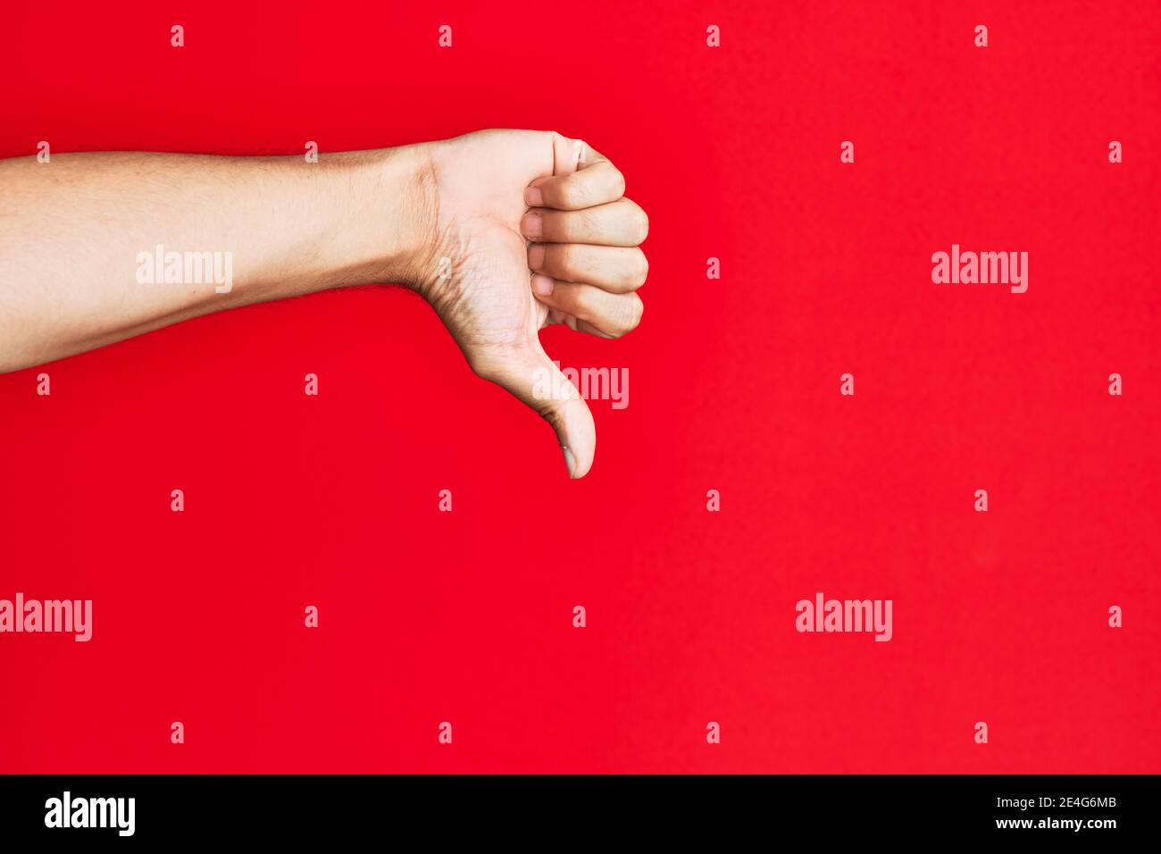 Arm of caucasian white young man over red isolated background doing ...