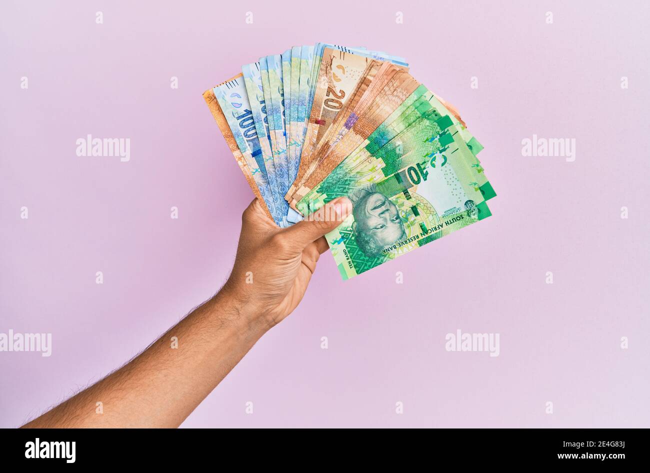 Hand holding south african rand hi-res stock photography and images - Alamy