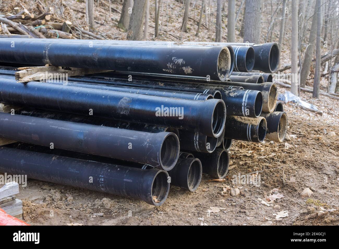 Plastic main black pipes on heap of polyethylene pipes for a water ...
