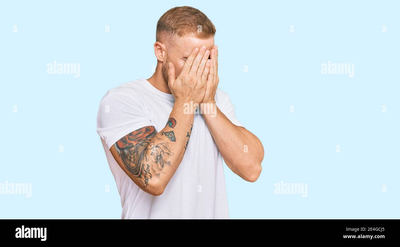 Young irish man wearing casual clothes with sad expression covering ...