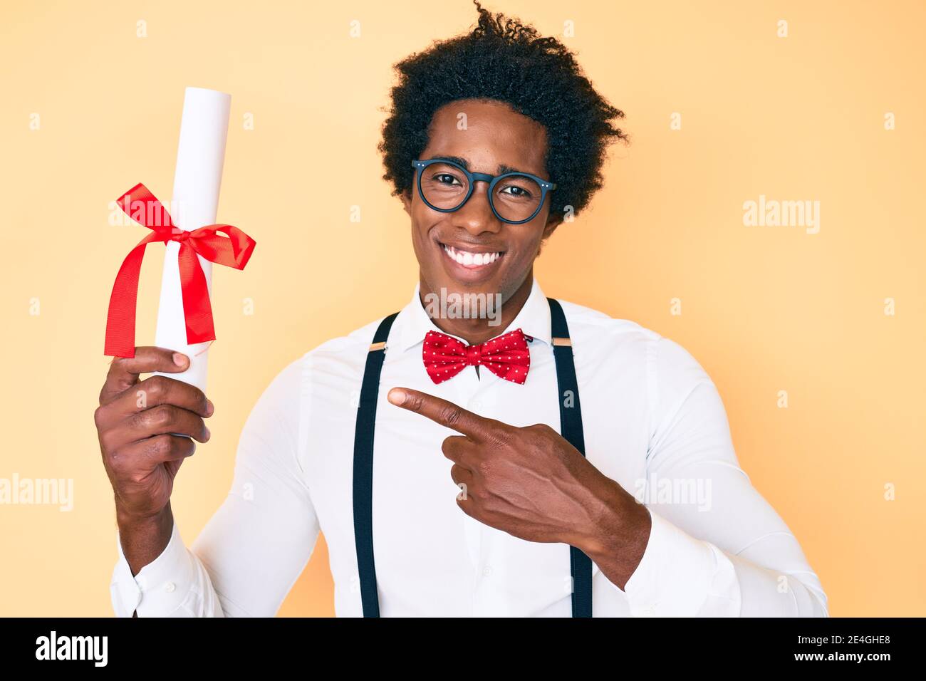 Handsome african american nerd man with afro hair holding graduate ...