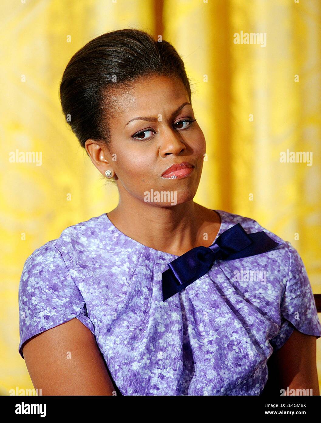 First Lady Michelle Obama listens during an event in the East Room of ...