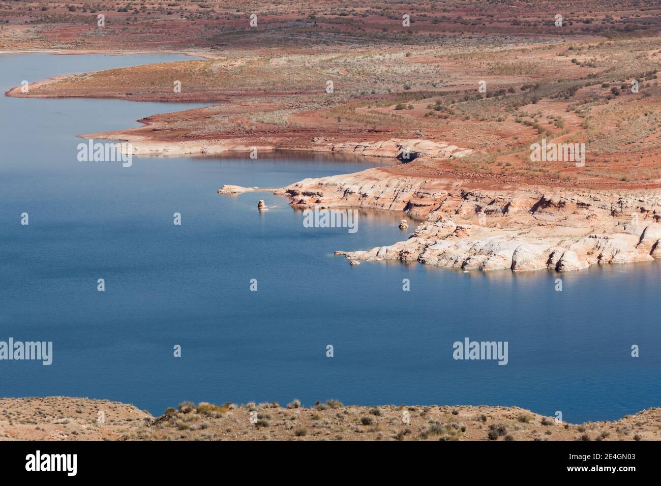 Receding waterline of Lake Powell showing newly exposed sandstone rocks ...