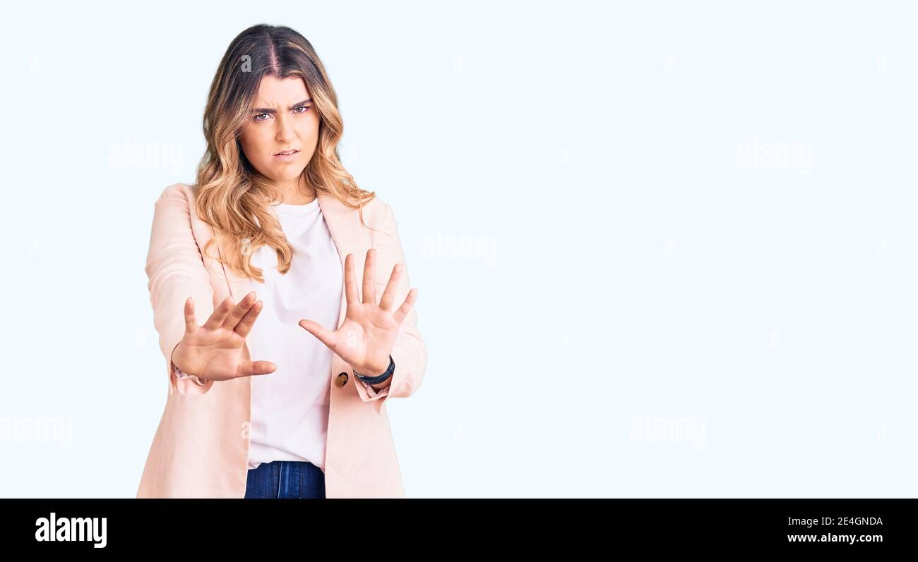 Woman pushing away hands hi-res stock photography and images - Alamy