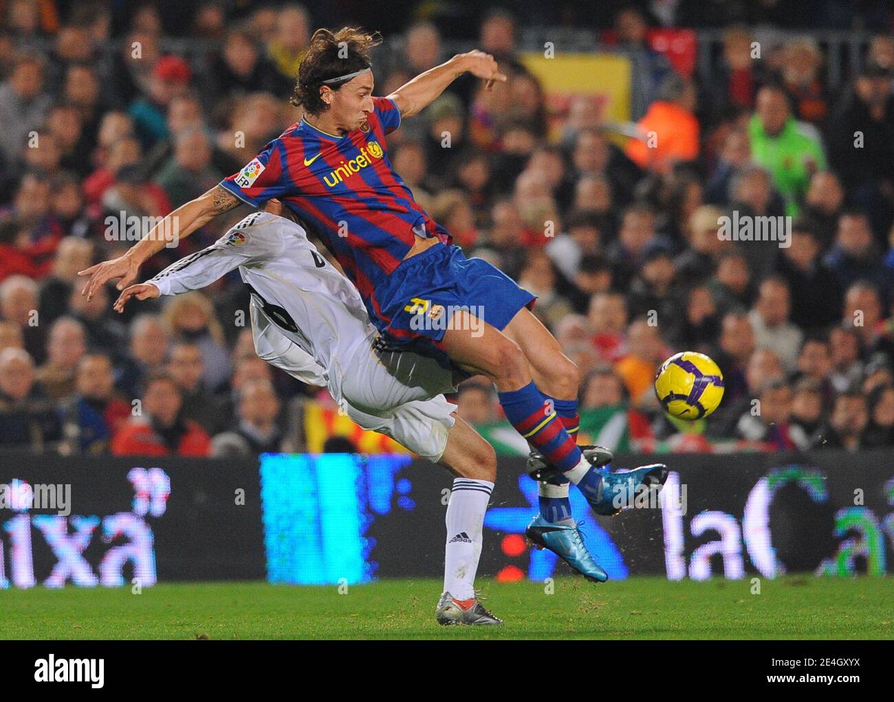 Real Madrid's Kaka tackles Barcelona's Zlatan Ibrahimovic during the ...