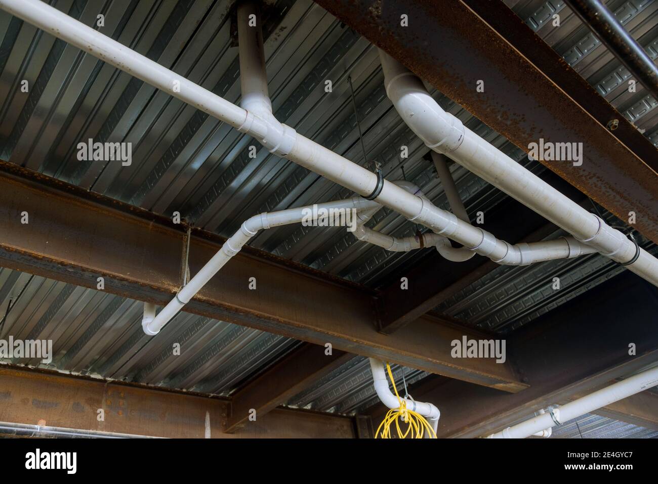 Plumbing rough-in in commercial building with pvc pipe in construction ...