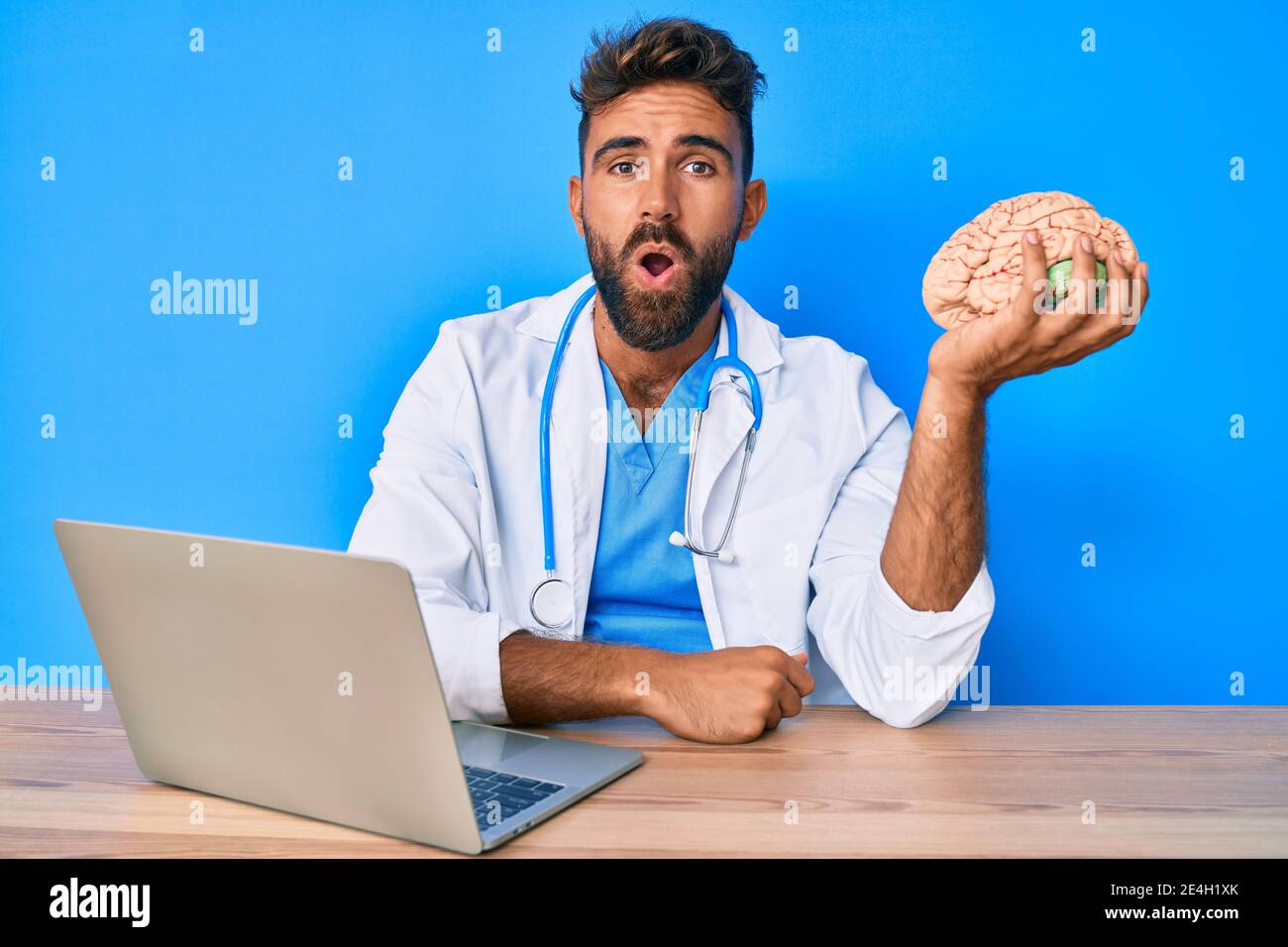 Young hispanic man wearing doctor uniform working at the clinic holding ...