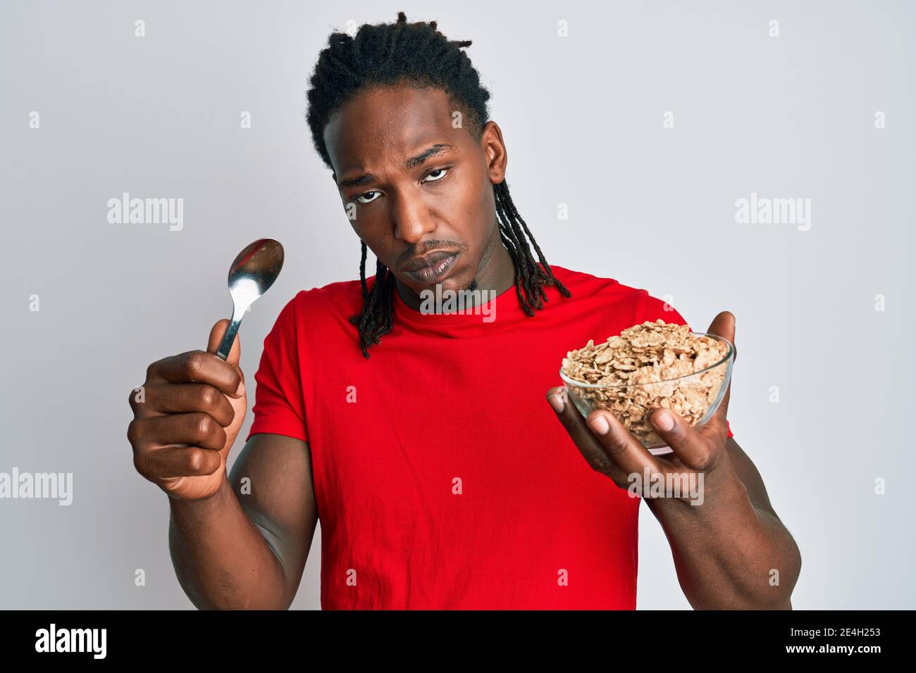 African american man with braids eating healthy whole grain celears ...