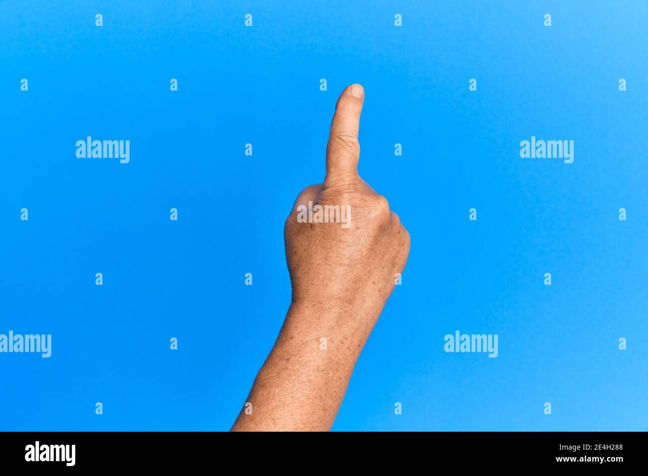 Hand of senior hispanic man over blue isolated background counting ...