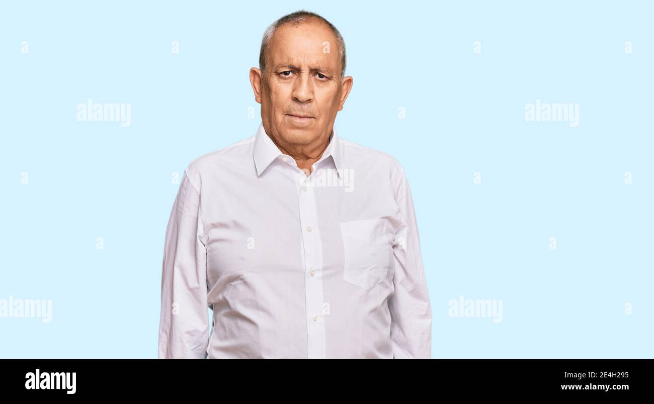 Handsome senior man wearing elegant white shirt depressed and worry for ...