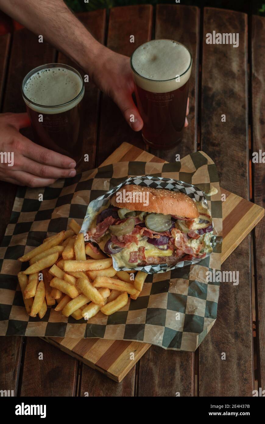 Vertical shot of a fast food serving of a burger and fries with two ...