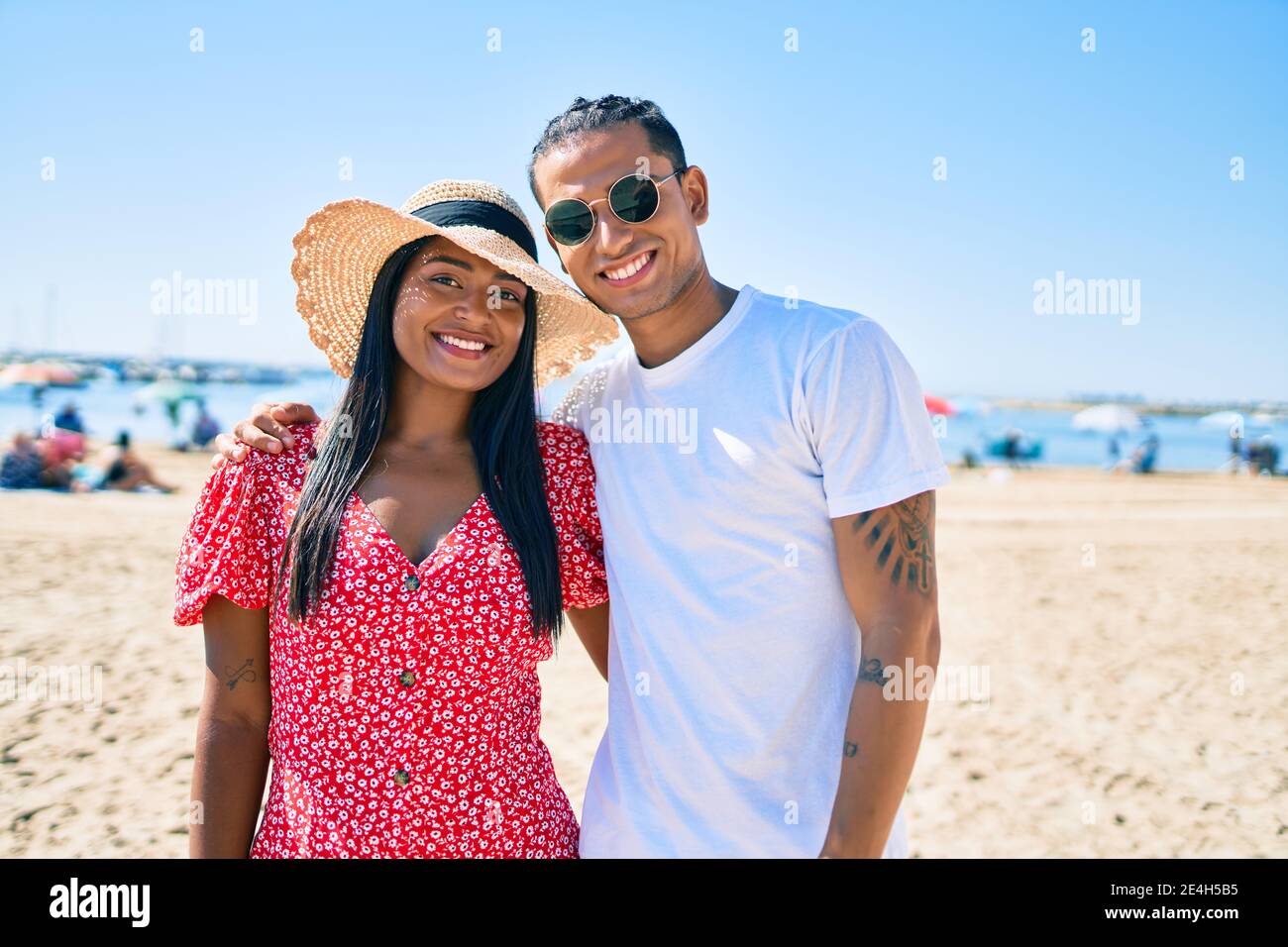 Young latin couple smiling happy and hugging at the beach Stock Photo ...