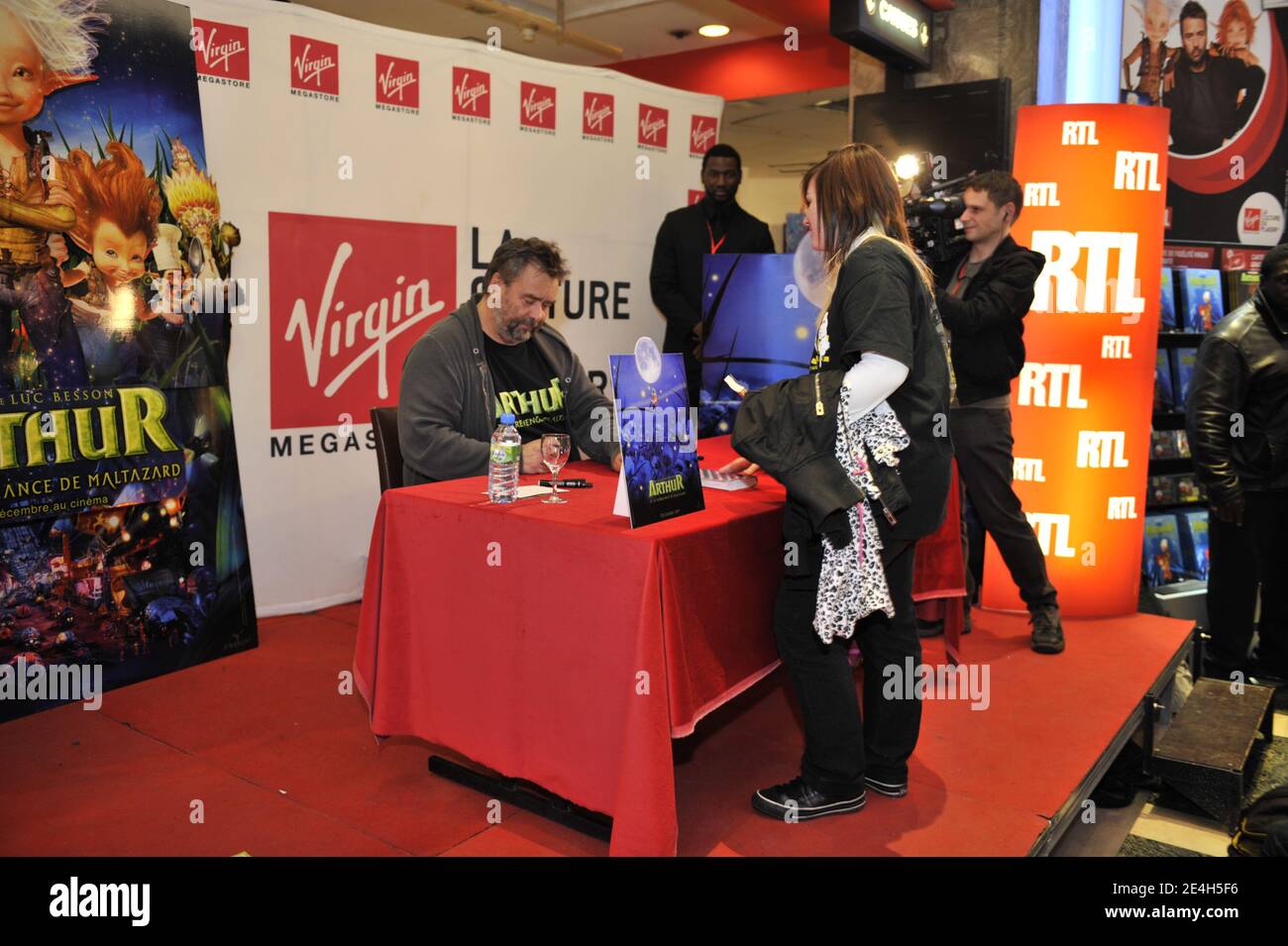 "French film director Luc Besson signs copies of his latest animated ...